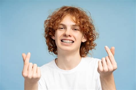 Premium Photo Attractive Curly Haired Redhead Male Teen Smiling With