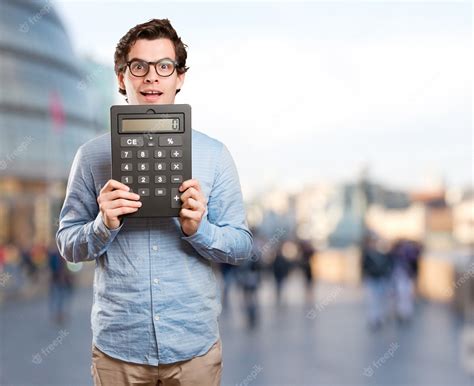 Premium Photo Happy Young Man Holding A Calculator