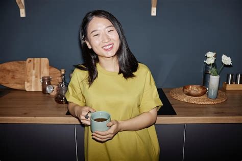 Premium Photo Cheerful Asian Girl In Kitchen