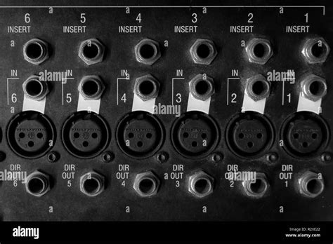 rear view of professional audio mixing console inputs an outputs stock