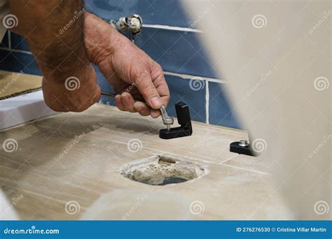 Unrecognizable Senior Plumber Installer Installing Toilet Drain Flange