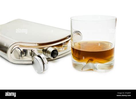 Close Up Of A Silver Metal Flask And A Glass With Liquid Alcoholic
