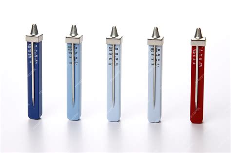 A Row Of Six White Thermometers With Different Temperature Readings On
