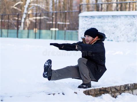Молодой человек в одежде зимы спорт делая сидения на корточках на одной ноге Стоковое