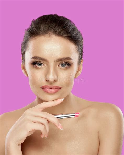 Attractive Caucasian Woman With Flawless Skin Holding A Pink Lipstick