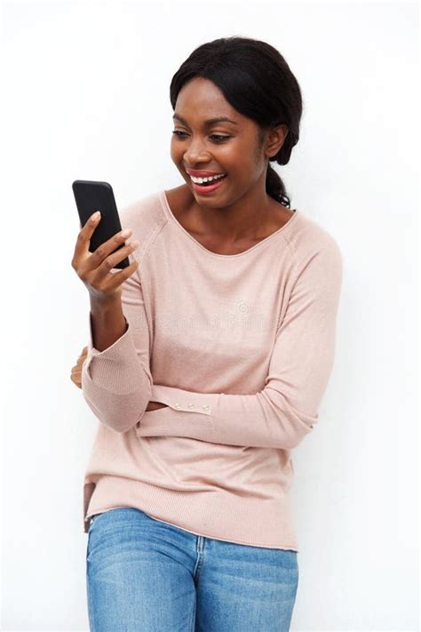 Beautiful Young Black Woman Laughing With Cellphone Against White