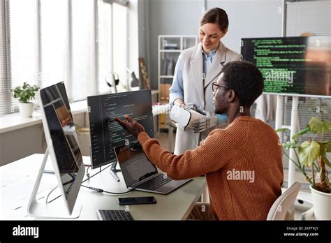 Software Developers Discussing Programming Code When Working On New