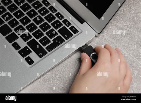 Woman Attaching Usb Flash Drive Into Laptop At Grey Table Closeup Stock Photo Alamy