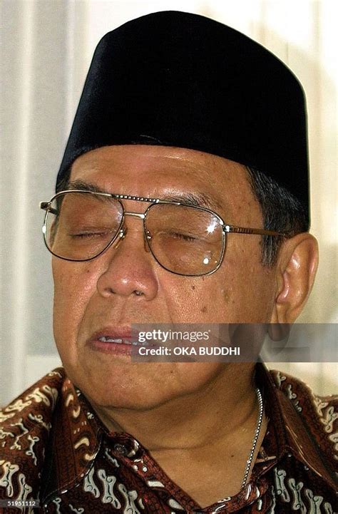 Indonesian President Abdurrahman Wahid Listens During A Meeting With