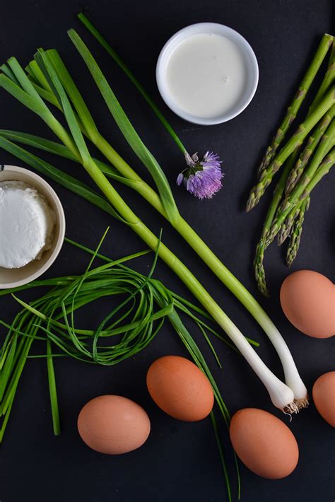 Asparagus And Goat Cheese Frittata Over Salad With Chive Flower