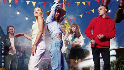 Side View Of Group Of Young Happy People Celebrating Having Party Of