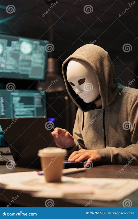 Dangerous Masked Thief Installing Virus To Hack System Stock Image