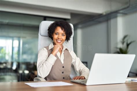 Confident Happy Young African American Woman Sitting At Office Desk
