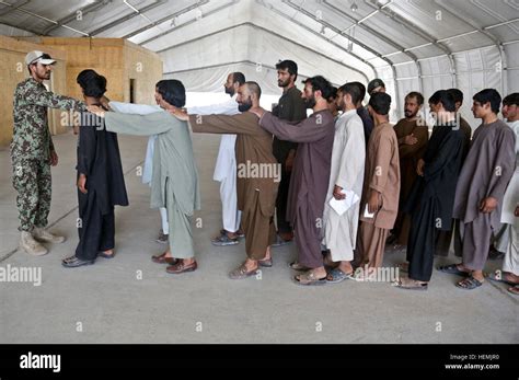 An Afghan National Army Soldier Aligns New Afghan Local Police Recruits