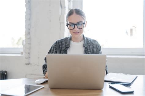 Premium Photo A Female Programmer Works Uses A Laptop Makes A Report