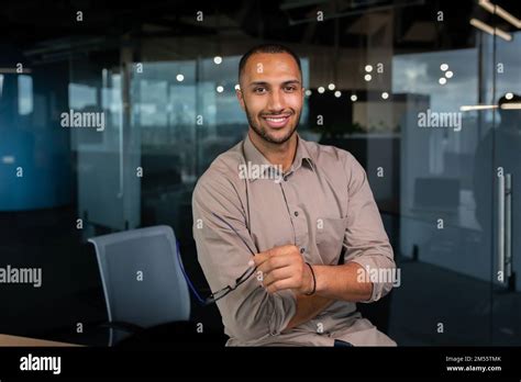 Portrait Of African American Businessman In Office Man In Shirt Standing Near Window Smiling