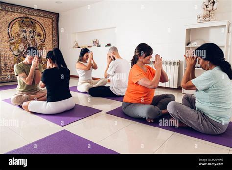 People In A Yoga Class They Do The Prayer Position With Their Hands