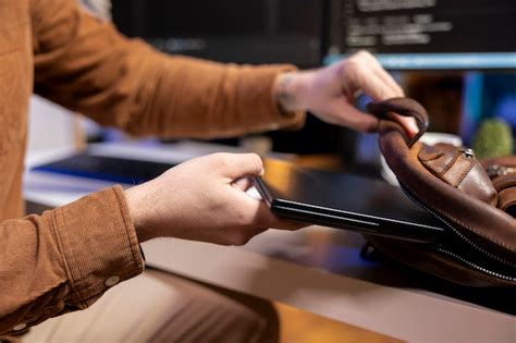 Premium Photo Programmer Packing Laptop In Backpack Leaving Office