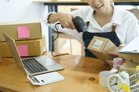 Young Asian Businesswoman Use Bar Code Scanner Scan The Barcode On The