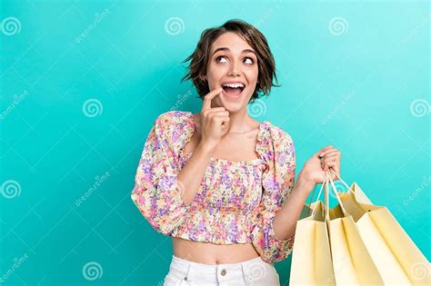 Photo Of Impressed Cheerful Lady Hold Boutique Bags Finger Touch Chin