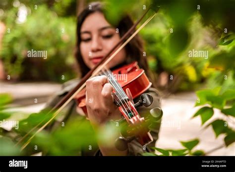 Girl With Her Violin Playing A Melody Outdoors Concept Of Smiling