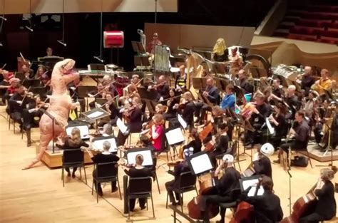 T Rex Conducts Orchestra Playing The Jurassic Park Theme In Viral