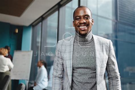 Happy African Businessman Smiling In Office Boardroom Jacob Lund