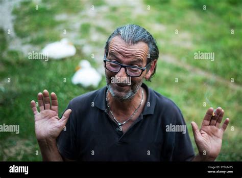 A 60 Year Old Serbian Man Exuding Vitality With Glasses Long Hair
