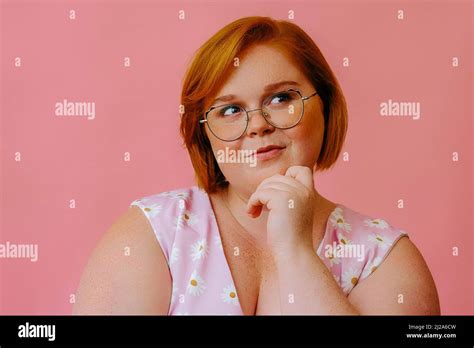 Smiling Young Woman Posing In Studio Over Pink Background Hand On Chin