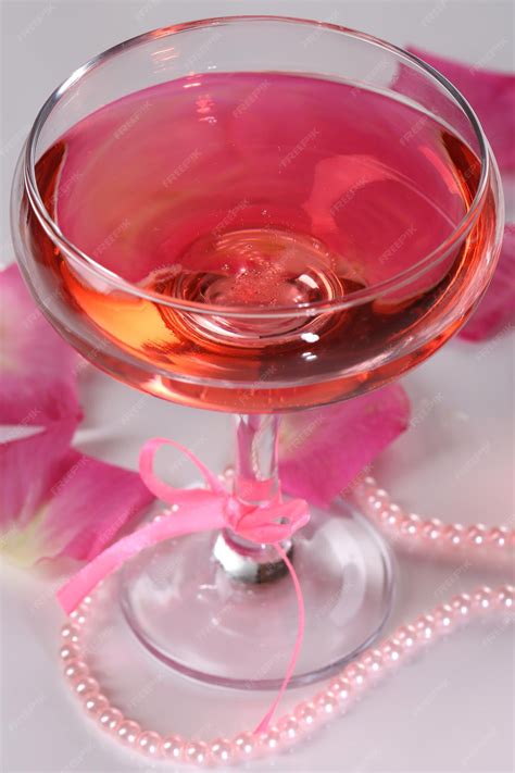 Premium Photo Composition With Pink Sparkle Wine In Glass And Rose