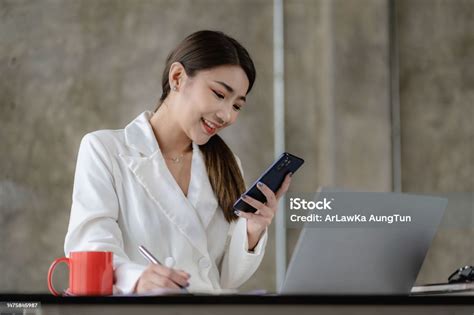 온라인 회의 스마트폰을 사용하여 집에서 스마트하게 일하면서 화상 통화 계획에 대해 동료 팀과 이야기하는 아시아 사업가 Brand