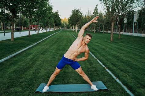 Premium Photo Full Length Of Shirtless Man Sitting In Park