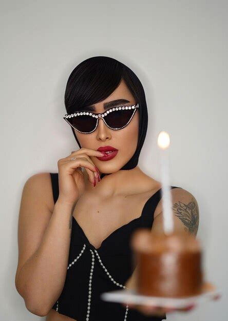 Premium Photo Portrait Of Young Woman Wearing Sunglasses Against