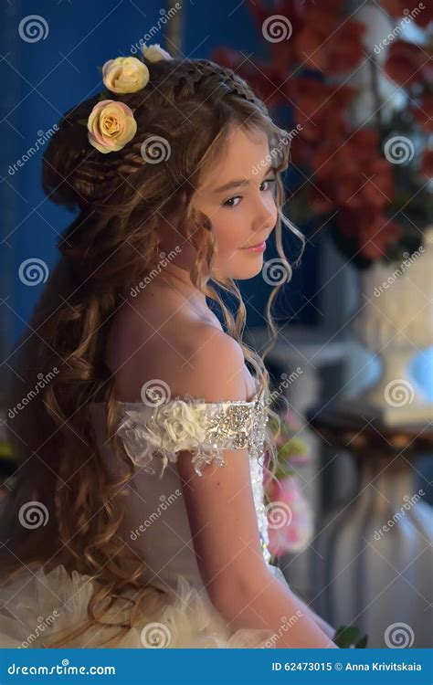 Young Princess With Long Hair And Flowers In Her Hair Stock Image