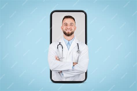 Premium Photo Smiling Young Male Doc On Phone Screen Blue Backdrop