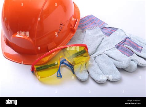 Orange Hard Hat Goggles And Safety Gloves On A White Background Stock
