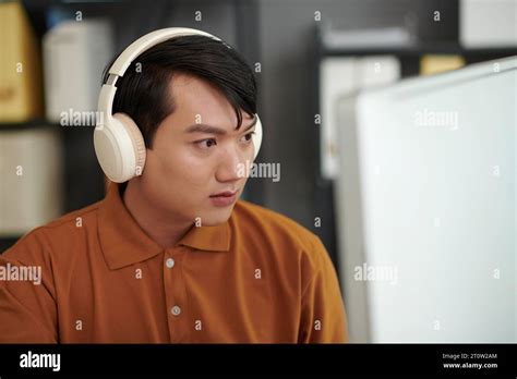 Portrait Of Developer Reviewing Programming Code On Computer Screen