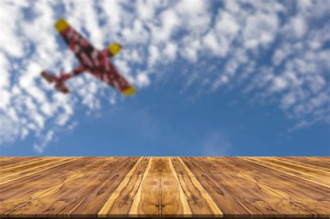 Premium Photo Wooden Table With Blur Sky And Plane Background