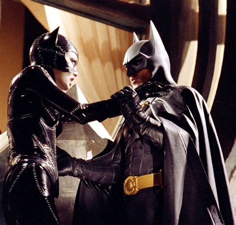 Two People Dressed As Batman And Catwoman In A Scene From The