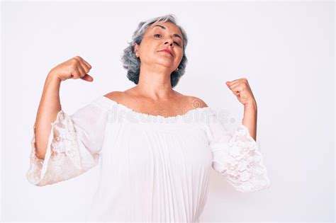 Senior Hispanic Grey Haired Woman Wearing Casual Clothes Showing Arms
