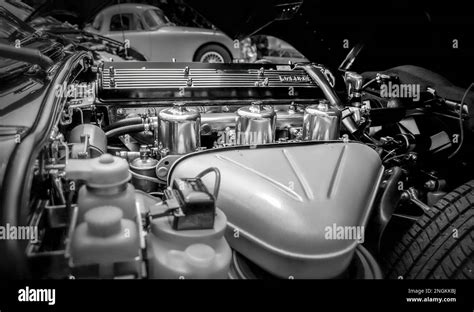 Close Up Of A 6 Cylinder Jaguar E Type Engine Bay Shot In Black And