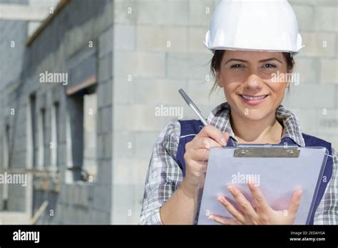 Engineer Checking Clipboard In Construction Site Stock Photo Alamy