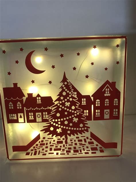 A Lighted Christmas Card With A Lit Up Tree