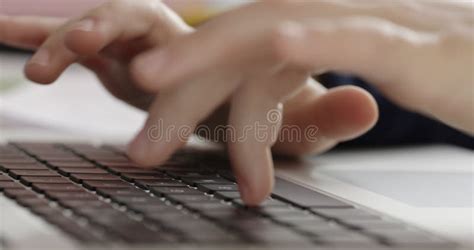 Young Boy Typing On Laptop Keyboard In Close Up View During Daytime