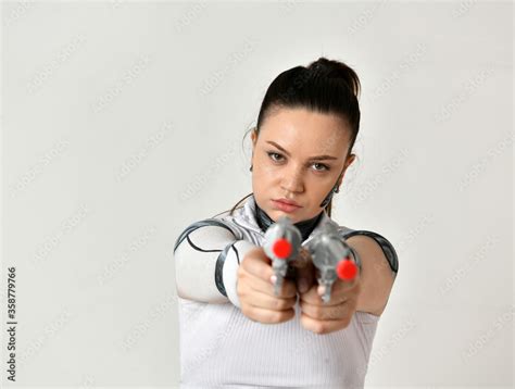 Beautiful Brunette Girl In A Robot Suit With A Serb Pistol Stock Photo