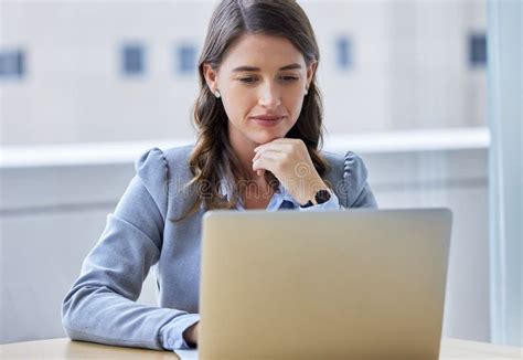 Typing Up Important Documents A Businesswoman Using Her Laptop At Work