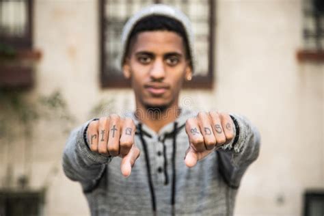 A Closeup Portrait Of A Young Man Shows Off His Tattoos In Nyc Stock