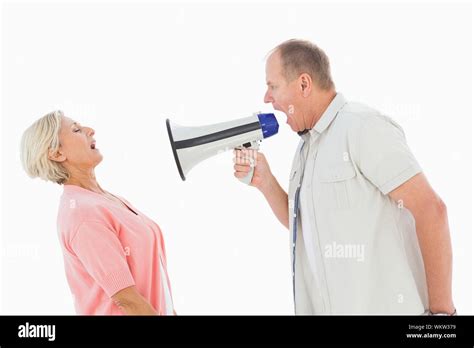 Man Shouting At His Partner Through Megaphone On White Background Stock Photo Alamy