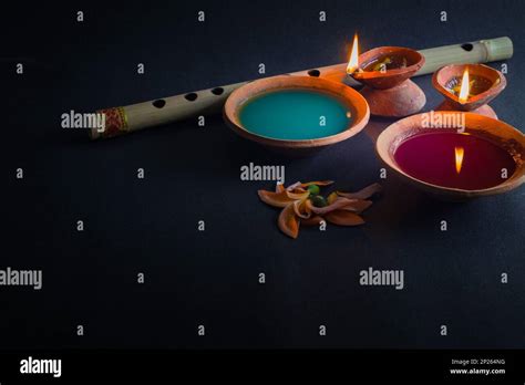 Happy Holi Celebration With Colors Cley Lamp And Bamboo Flute
