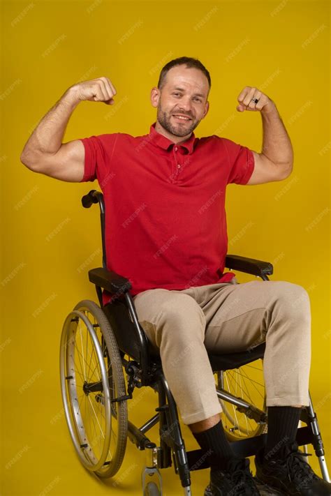 Free Photo Portrait Of Disabled Man In A Wheelchair Showing Bicep